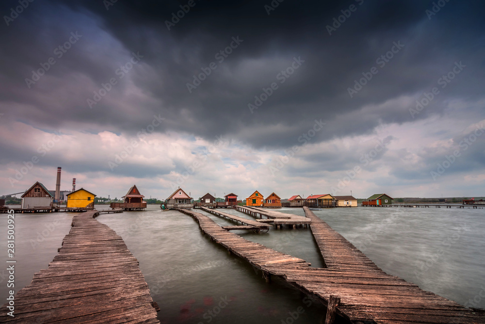 Bokod floating village with piers and fishing wooden cottages, in one ...