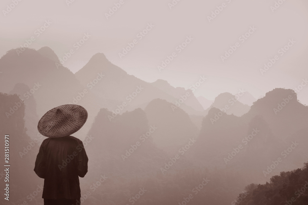 Rear view of man in traditional straw hat standing outdoors Stock Photo ...