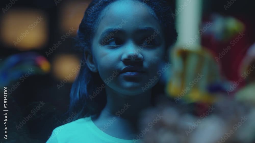 curious girl looking at fish in aquarium child watching colorful sea ...