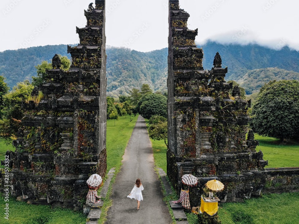 Unrecognizable Tourist woman walking through Traditional Balinese Hindu ...