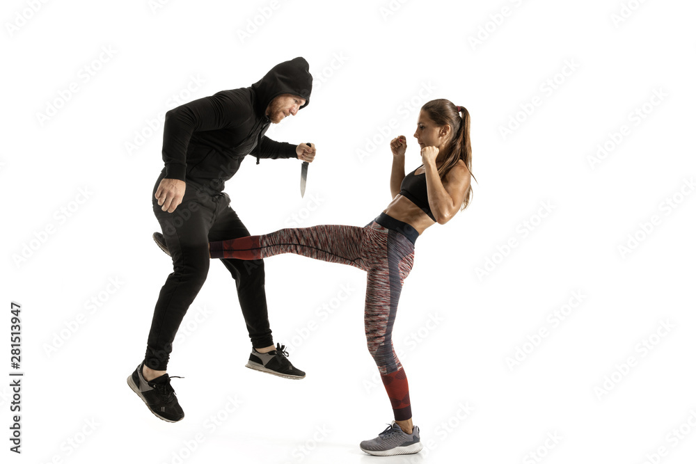 Man in black outfit and athletic caucasian woman fighting on white ...