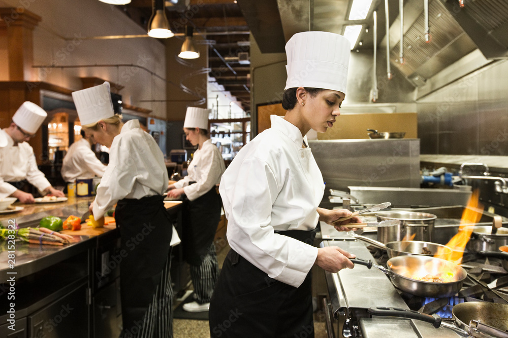 Chefs working in commercial kitchen Stock Photo | Adobe Stock