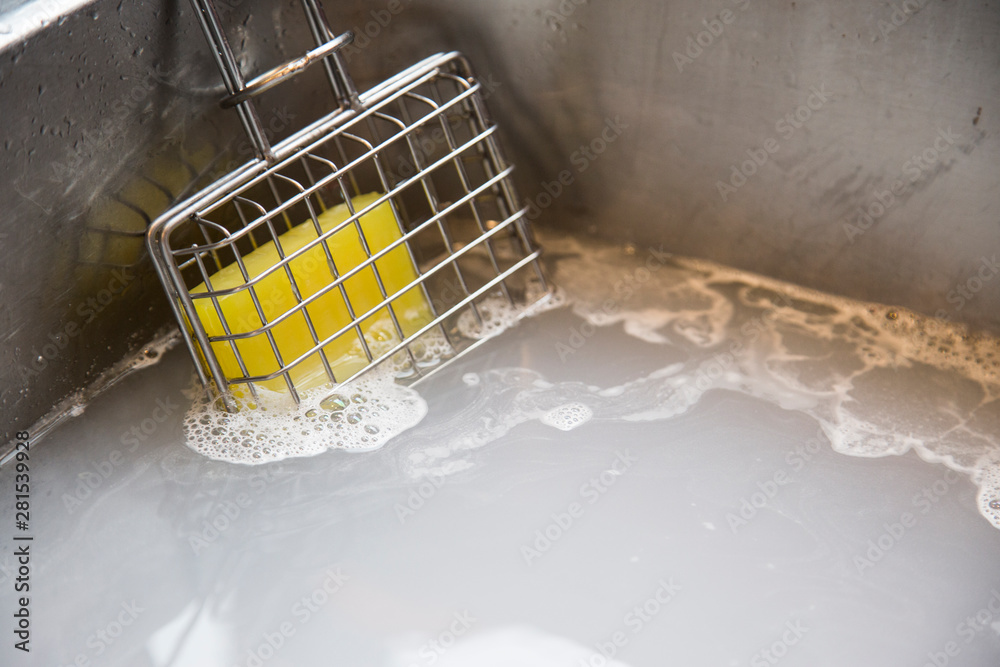 Soap shaker in use in the kitchen. Used to create soapy water to wash ...