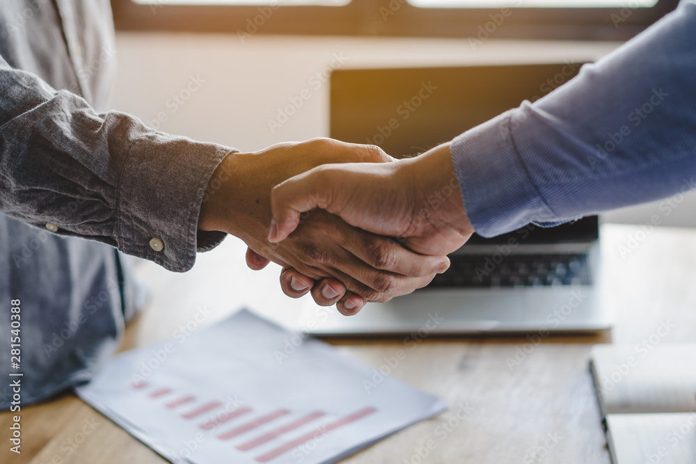 Two businessmen handshaking in meeting after final project agreement ...
