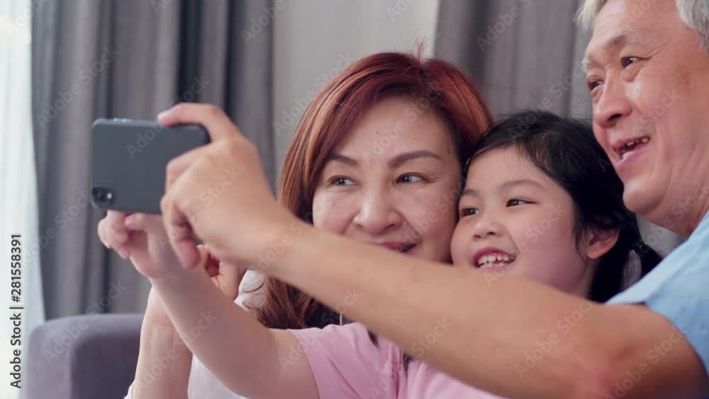 Asian grandparents selfie with granddaughter at home. Senior Chinese ...