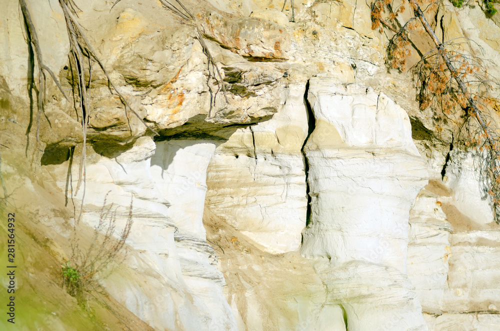 The clay cliff by the river with erosive types of terrain and exposed ...