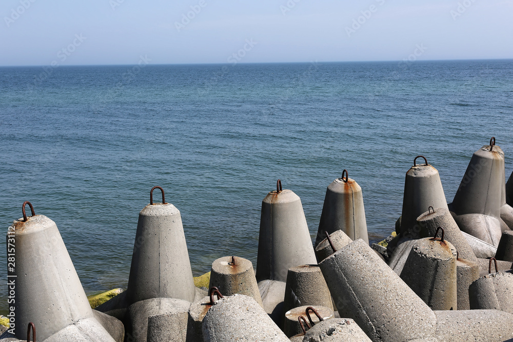 Offshore breakwater tetrapod blocks closeup, concrete blocks along the ...