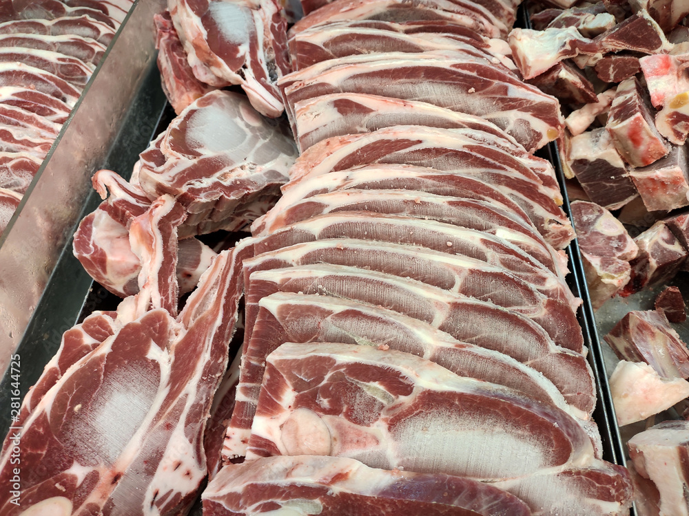 Frozen meat cut into cubes and slices and allowed to melt on the table ...