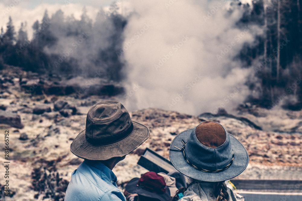 Tourist family couple enjoy geyser steam view with their kids in ...