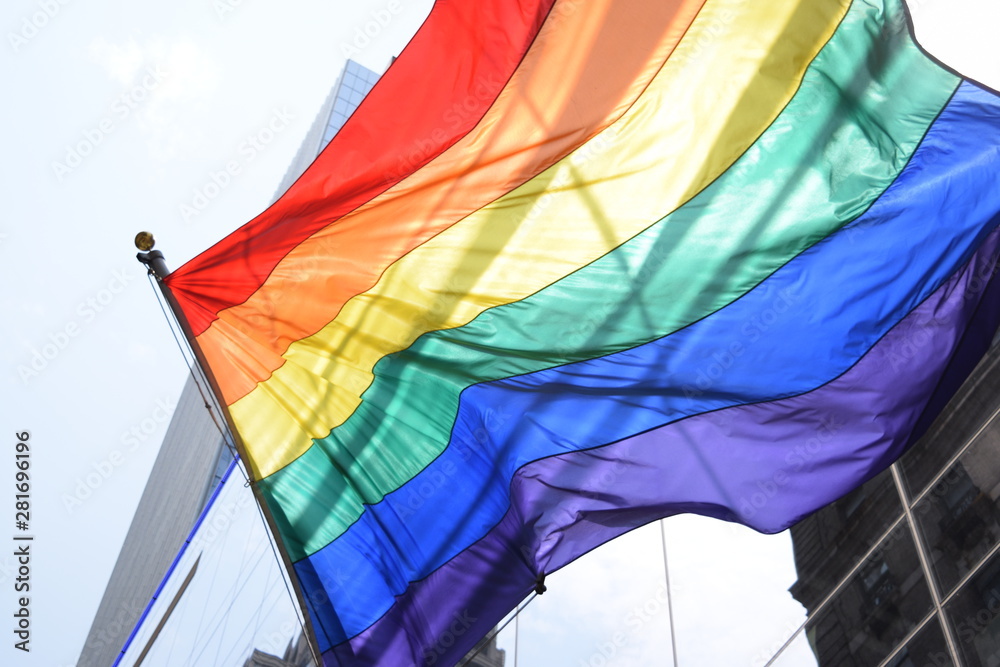 Pride flag on corporate building in big city. Pride month celebrations ...