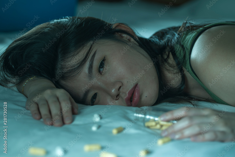 young beautiful desperate and wasted addict Asian Chinese woman taking ...