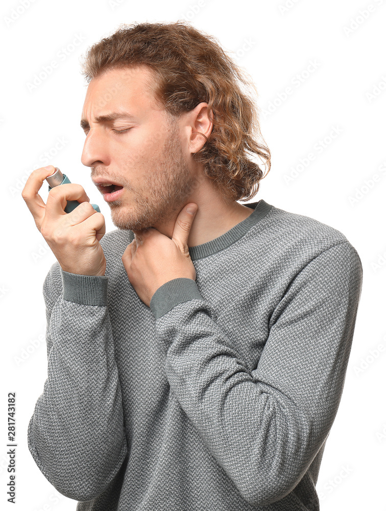 Young man with inhaler having asthma attack on white background Stock ...
