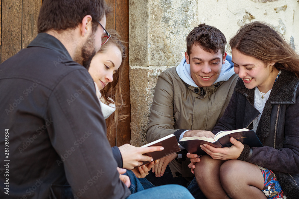 Christian worship and praise. Happy friends reading the bible together ...