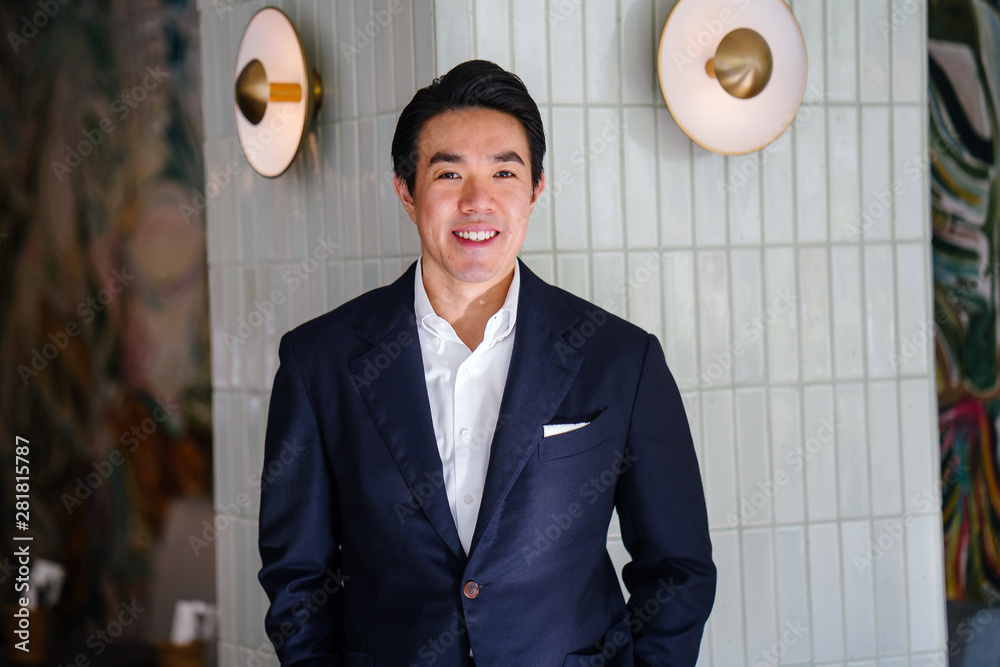 Portrait of a handsome, good looking and attractive Chinese Asian man in a well-tailored suit in ...