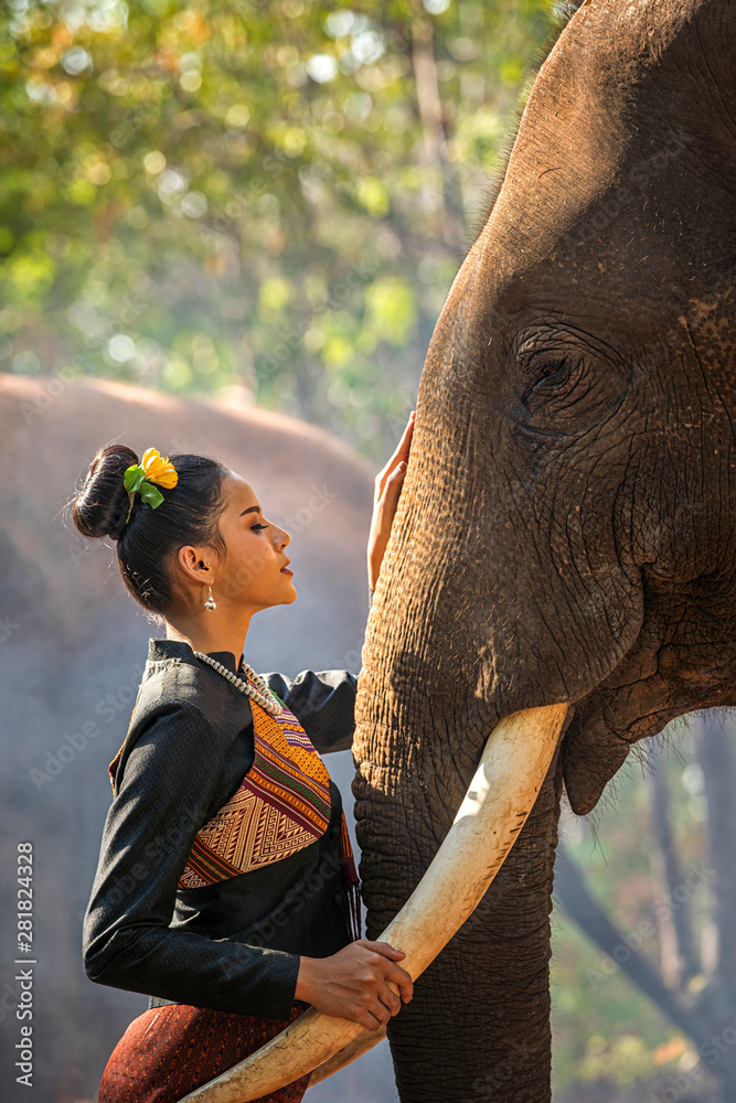 Kui's young Women wearing native dresses are living with elephants ...