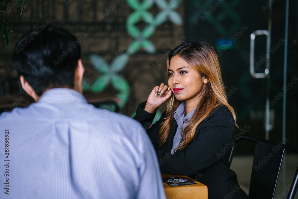 A beautiful and young Asian woman is smiling confidently as she ...