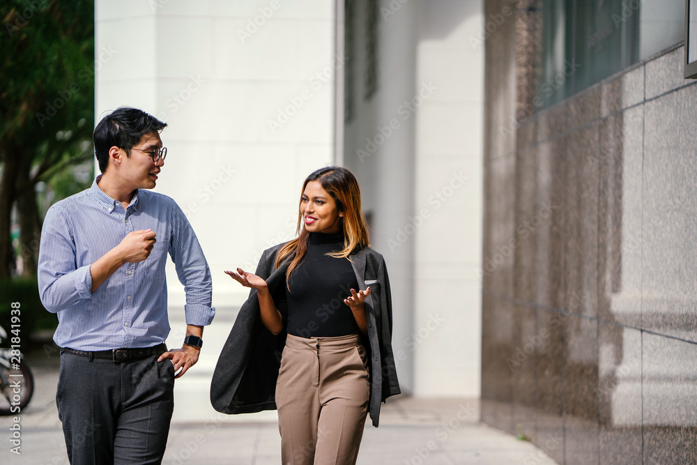Portrait of two diverse Asian business people (colleagues meeting for ...
