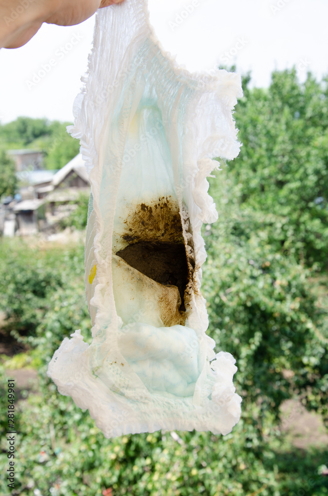 dirty diaper with poop on a white background in hands and close Stock ...