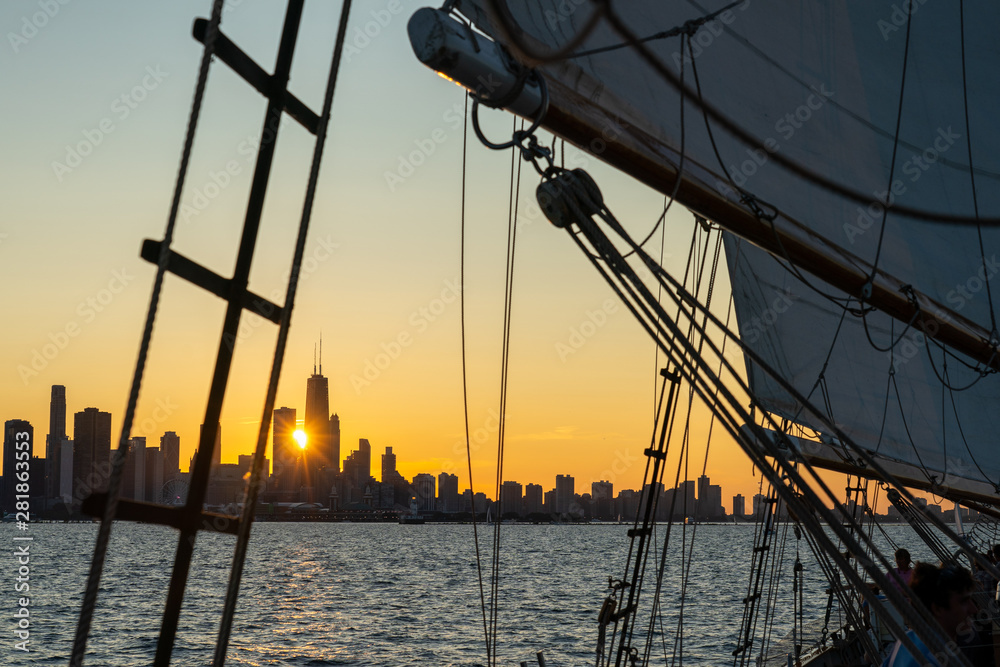 Chicago sunset with sunburst from deck of schooner with sails, rigging ...