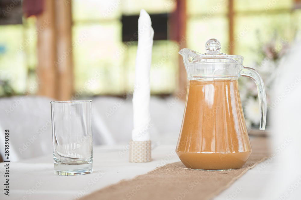 Jug of traditional Peruvian drink "Chicha de Jora" on well lit ...