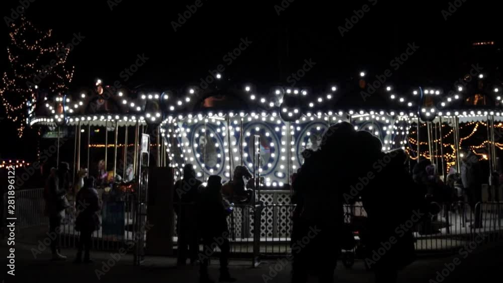 Brightly lit flashing light vintage carousel at winter light festival ...