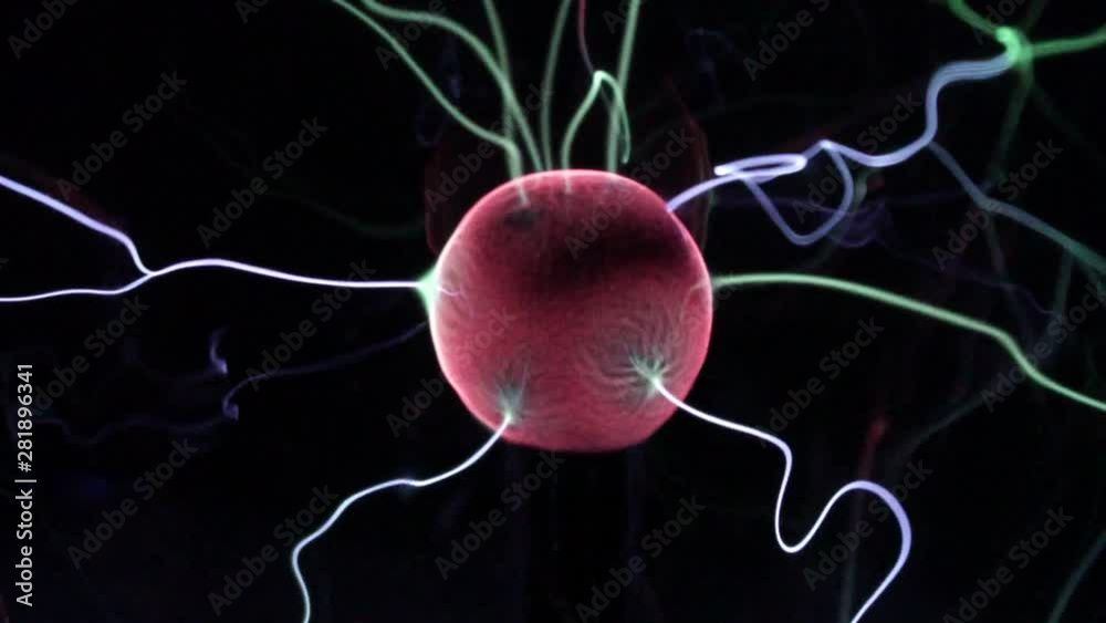 Plasma ball lamp close up, moving electric rays from the ball on black ...