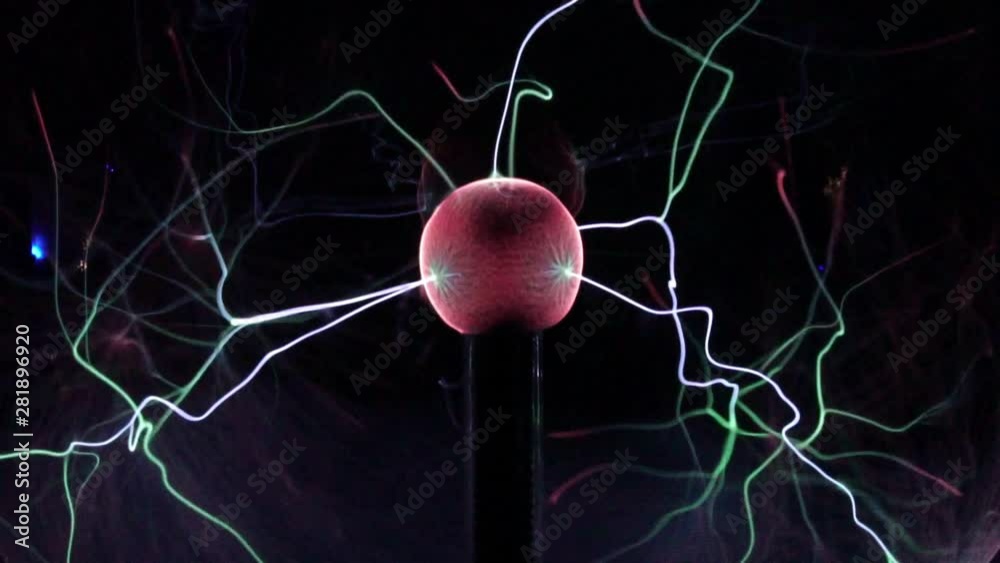 Plasma ball lamp close up, moving electric rays from the ball on black ...