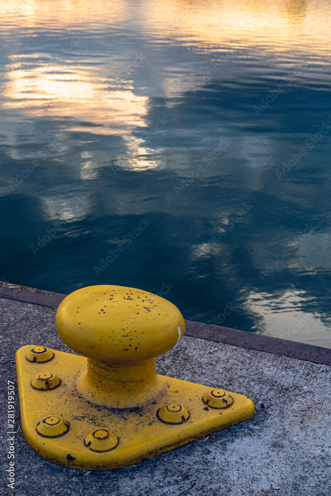 harbor bollard, anchor for ship berthing at quay wall on sky sunset ...