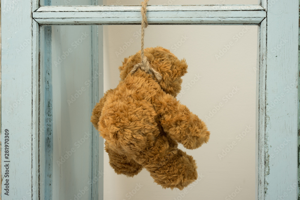 teddy bear hanging on old window Stock Photo | Adobe Stock