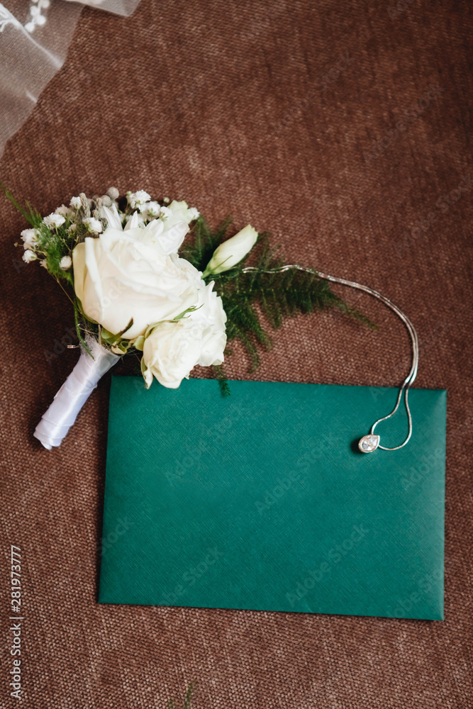 Invitation envelope in green on a dark background with a wedding ...
