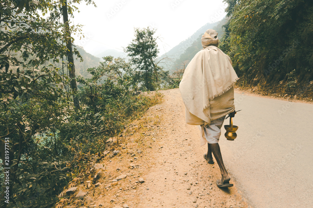 Indian renounced sadhu leaves on the way to the forest. A wandering ...