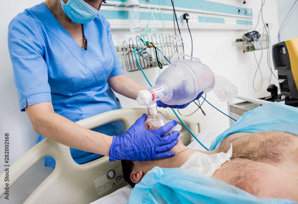 Doctors give resuscitation to a male patient in the emergency room ...