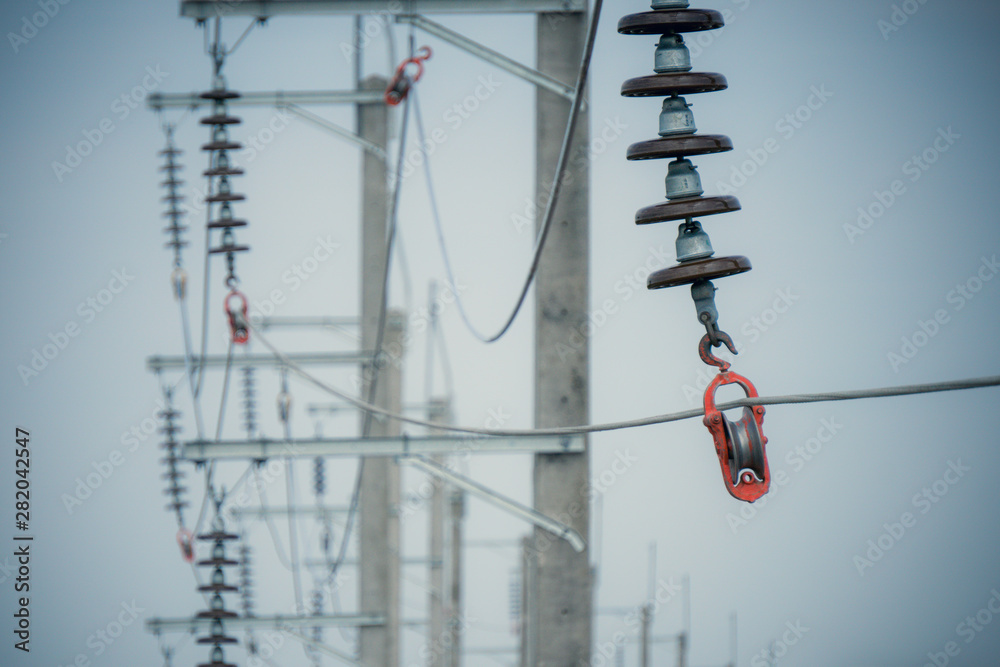 Construction process install aluminum electrical wires with insulators ...