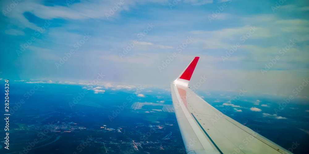 Airplane wing over the sky background, view from window Stock Photo ...