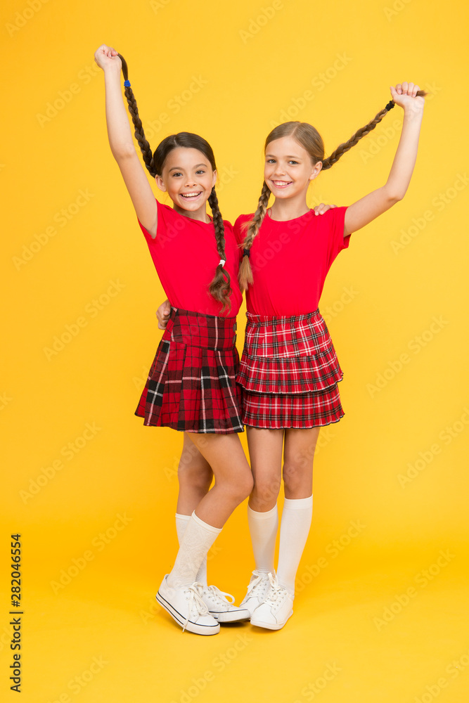 True friends. Happy small girls wearing same outfits. Friends enjoying ...