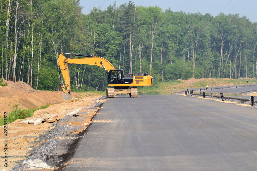 Crawler Excavator digging bucket on construction of high-speed bypass ...