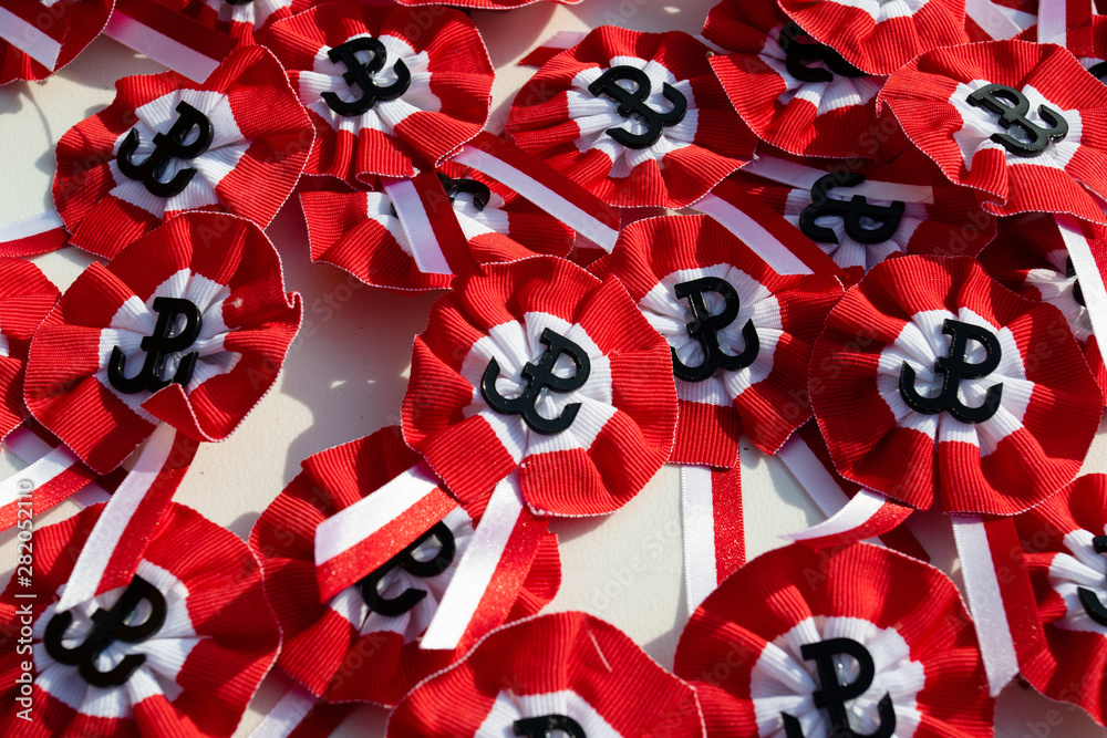 Many badges in the with an anchor symbol of the Warsaw Uprisingcolors ...