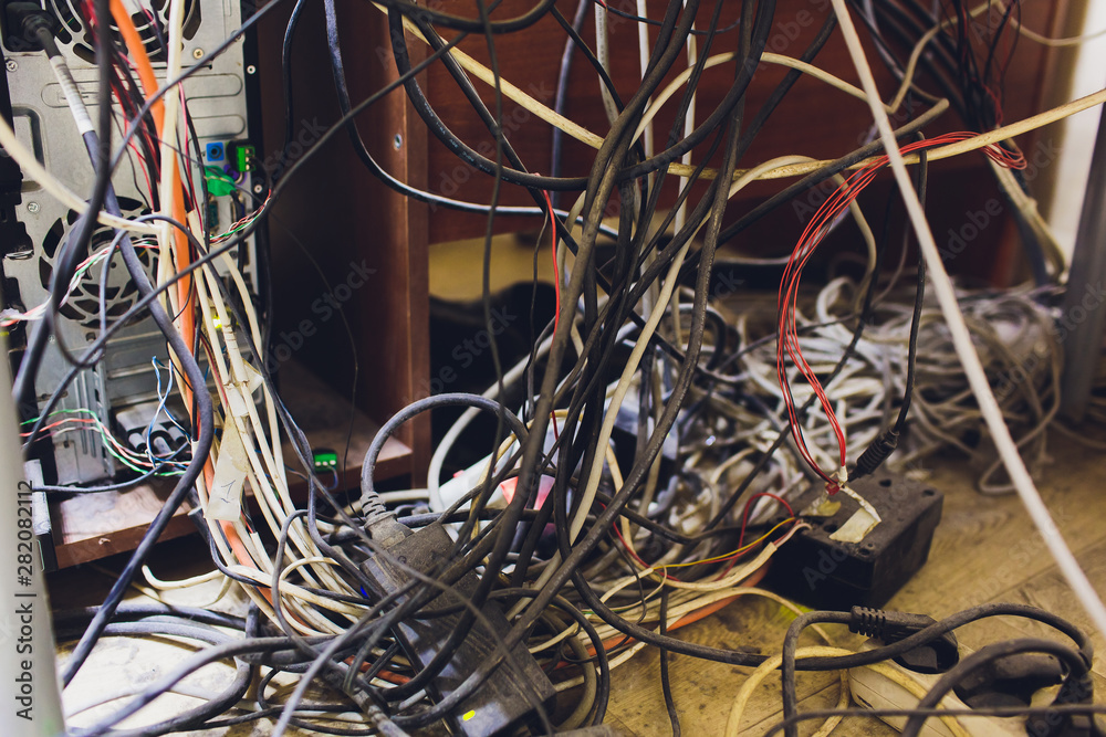 Concept of clutter in office. Unwound and tangled electrical wires ...