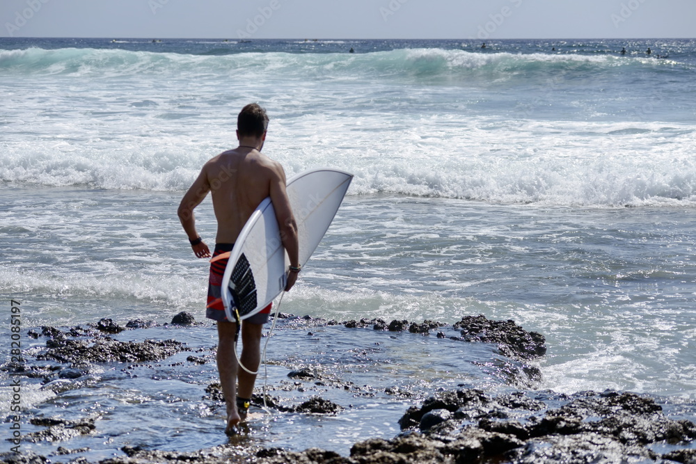 Young pro surfer surfs a big barrel wave in popular surf spot in ...