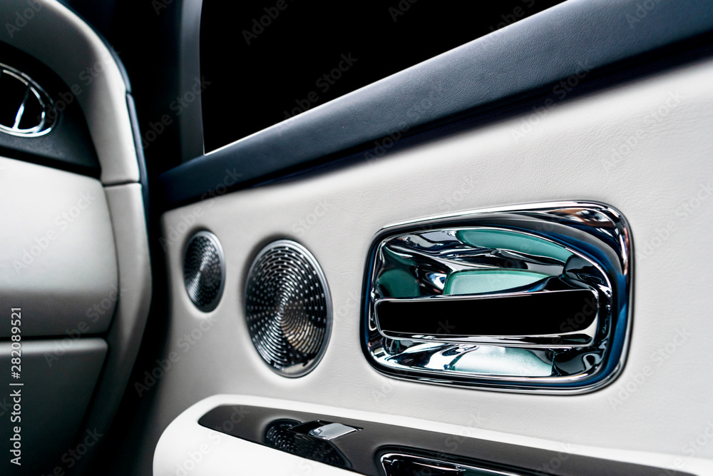 Door handle with power window control buttons of a luxury passenger car ...