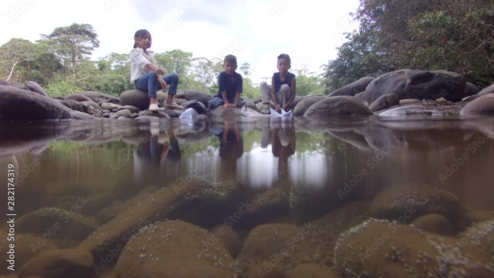Indigenous Kids Having Fun Playing With Paper Boats On The River In The ...
