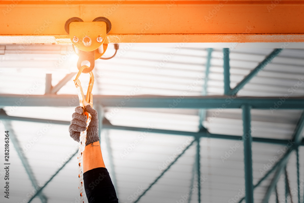 Construction worker wearing safety harness and safety line working high ...