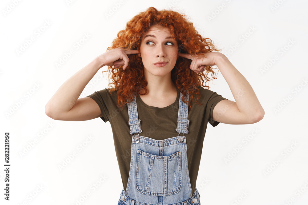 Silly cute redhead curly-haired girl looking unbothered and uninvolved ...