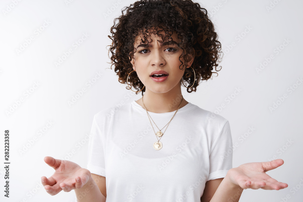 Wtf going on. Puzzled intense young attractive girlfriend shrugging ...