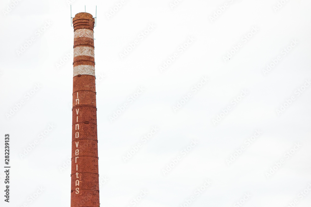 Smokestack in shape of wine bottle neck with text In vino veritas ...