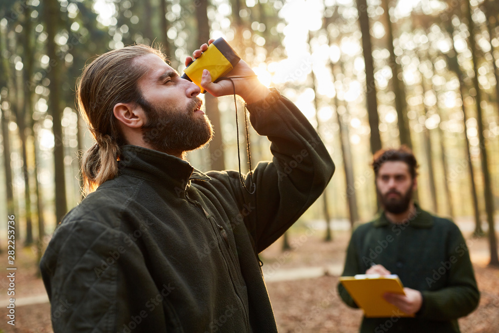 Two foresters or foresters determine tree height Stock Photo | Adobe Stock