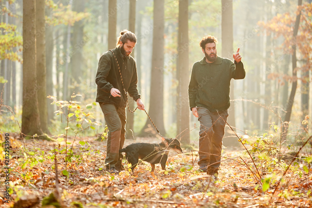 Two hunters with hunting dog on a hunt Stock Photo | Adobe Stock
