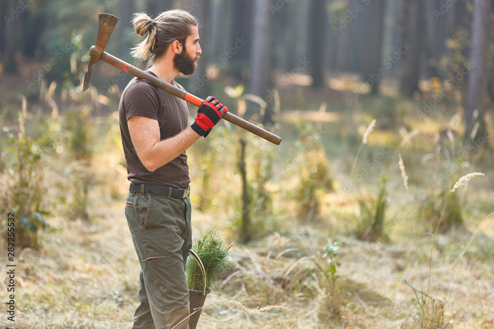 Young forest farmer in a nursery in the forest Stock Photo | Adobe Stock