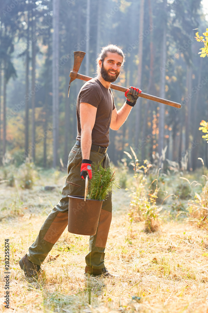 Young forest worker at the afforestation Stock Photo | Adobe Stock