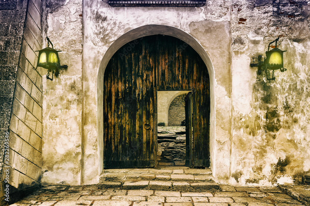 Old beautiful castle gate with street lamps. Ukraine. Olesky castle ...